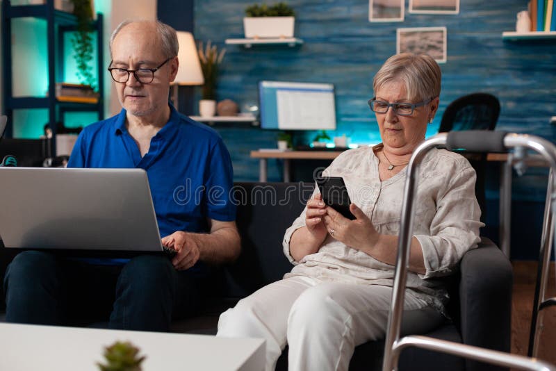 Retired Elderly Couple with Smartphone and Laptop Stock Photo - Image ...