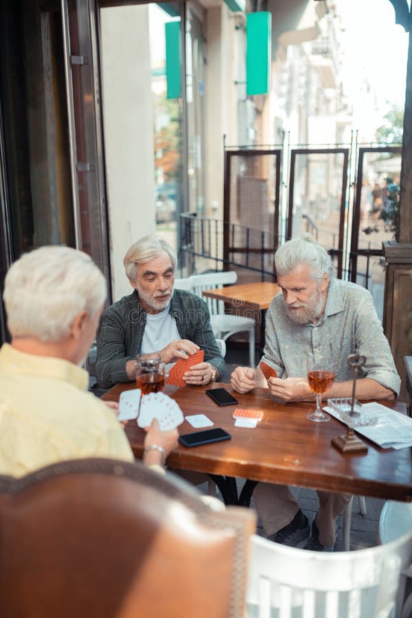 Retired Men Playing Cars while Sitting Outside Pub Stock Photo - Image ...