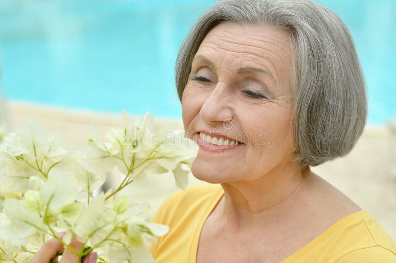 Retired Woman Posing with Flowers Stock Photo - Image of woman, lady ...