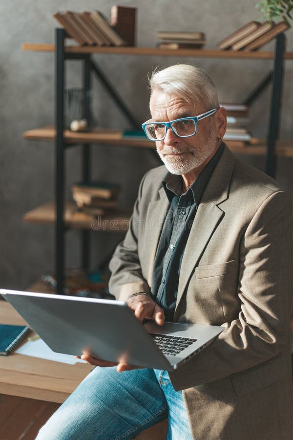 Retired Work. a Provincial Man in a Suit Sits at the Table and Holds a ...