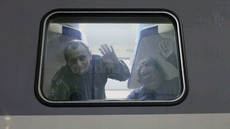 Retiree Man and Woman Wave Hands Near Window of Stock Footage - Video ...