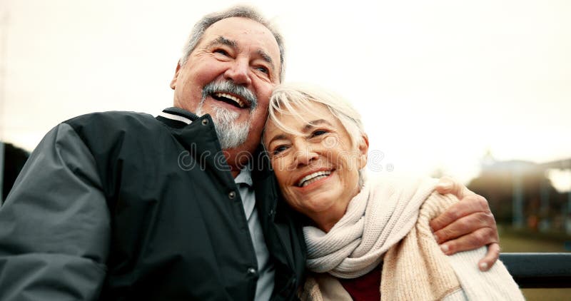 Retirement Hug And Senior Couple On Bench At Park With Happiness Or
