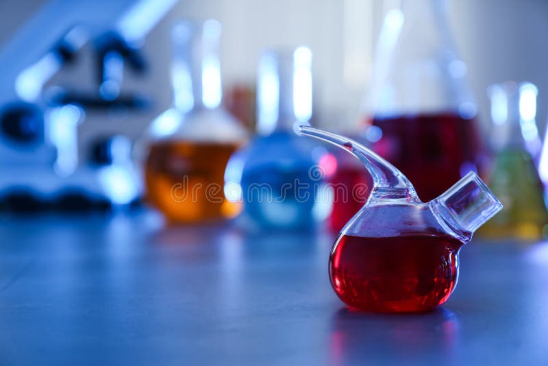 Retort Flask on Table Against Blurred Background. Chemistry Glassware ...