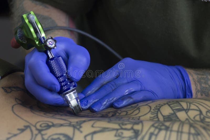 Ink re touching up stock photo. Image of tattoo, tattoogun - 125700864