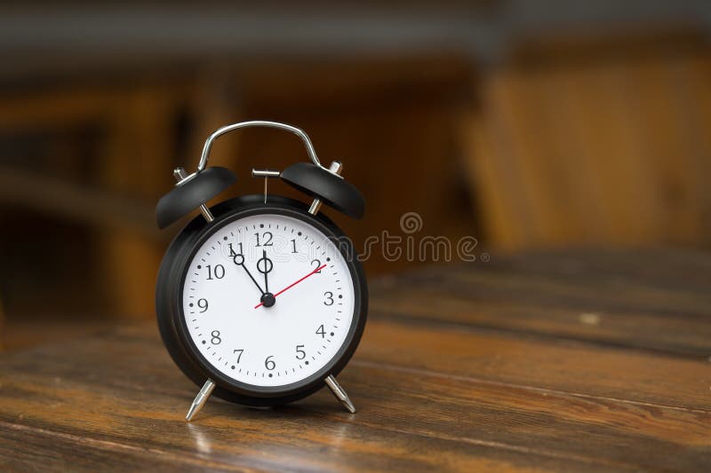 Retro Alarm Clock with Five Minutes To Twelve O`clock. Stock Photo ... Retro Alarm Clock with Five Minutes To Twelve O`clock. Stock Photo ...