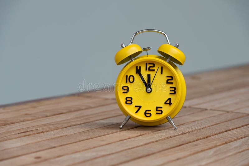 Retro Alarm Clock with Five Minutes To Twelve O`clock. Stock Image ... Retro Alarm Clock with Five Minutes To Twelve O`clock. Stock Image ...