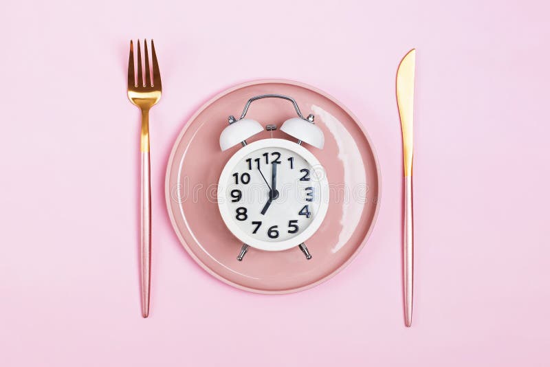 Retro Alarm Clock on Plate with Fork and Knife Isolated on Pink ... Retro Alarm Clock on Plate with Fork and Knife Isolated on Pink ...