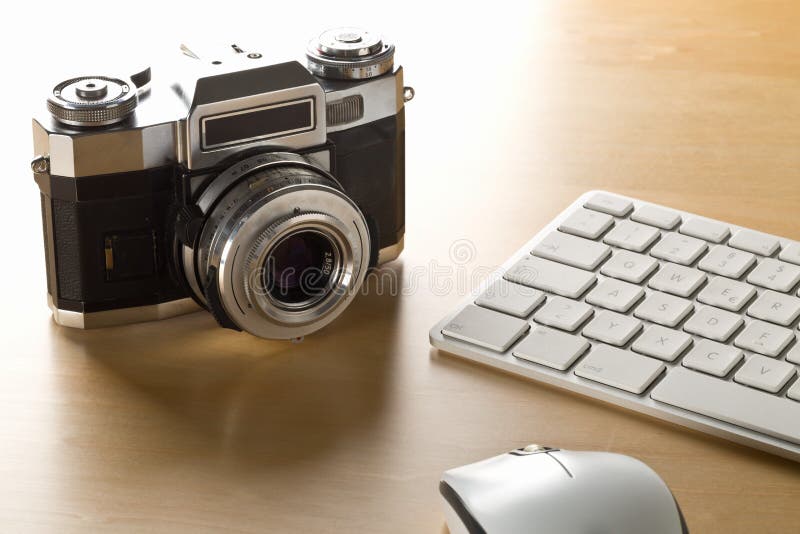 Retro Analog SLR Camera Next To Computer Keyboard and Mouse on Wooden ...