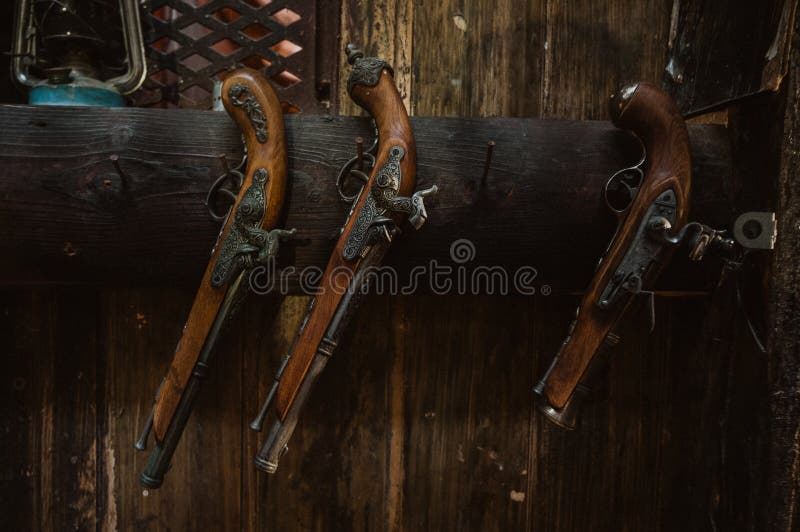 Retro, Antique Pistols Muskets Hanging on the Wall Stock Image - Image ...
