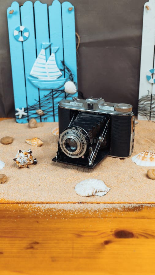 Retro Camera on the Sand between Seashells Against the Backdrop of ...