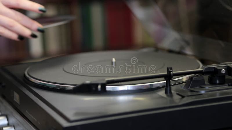 Retro Electronic. a Woman`s Hand Changes the Disc on a Vinyl Record ...