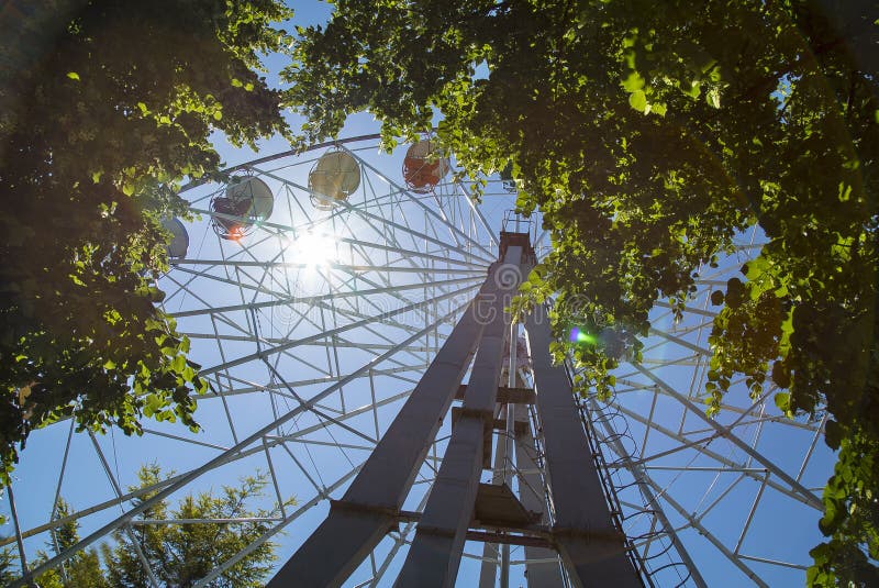 Retro Ferris Wheel on Blue Cloudy Sky and Solar Flare Stock Image ...