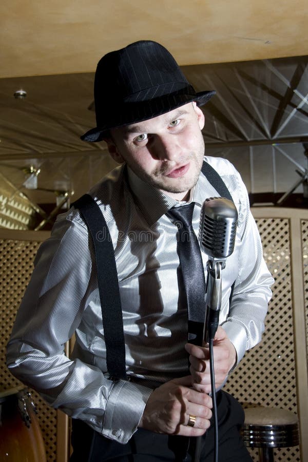 Retro Gangster Woman in a Brown Cloak and Black Hat with Airguns in ...