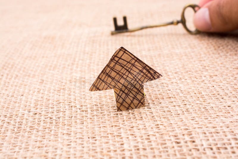 Retro Key and an Arrow Cut Out of Brown Paper Stock Photo - Image of ...