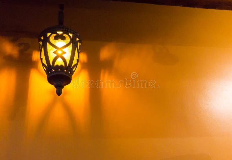 A Vintages Lamp Hanging on Wall. Old Light Glowing in the Dark Stock ...