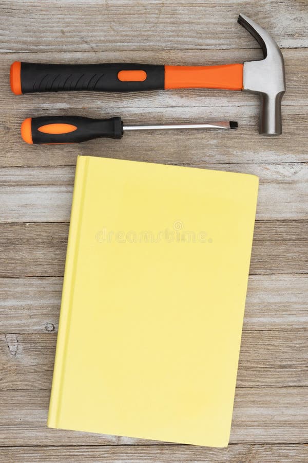 Retro Orange Screwdriver and Hammer and Book on Wood Stock Image ...