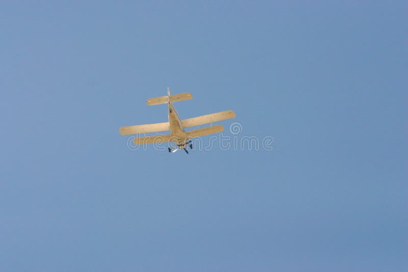 Retro Style Biplane Flying in the Air Against Blue Sky Stock Photo ...