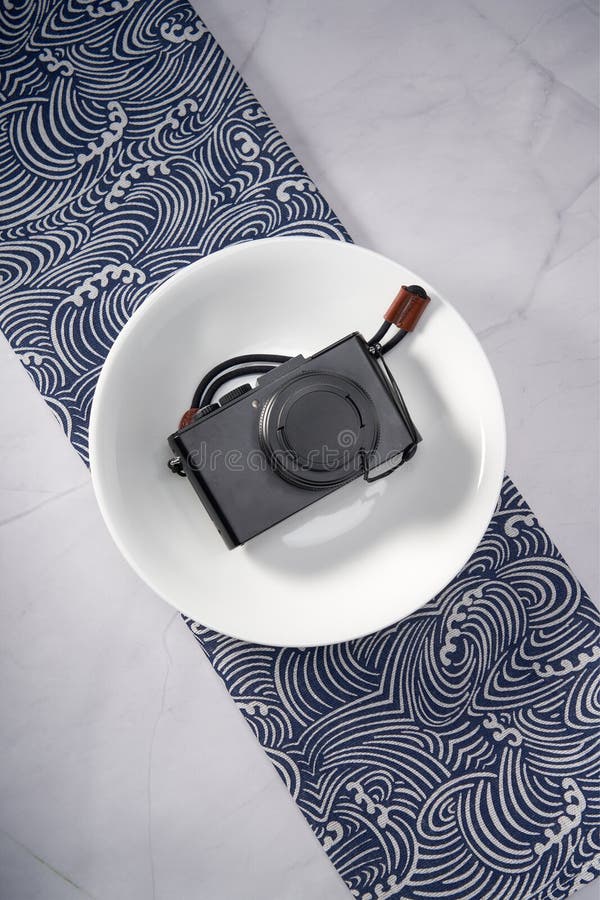 A Retro Style Camera is Placed on a White Ceramic Dinner Plate Stock ...