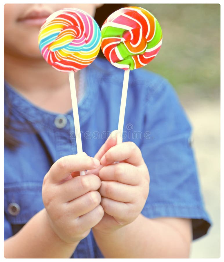 Female Hand Holding Lollipops Stock Image - Image of studio, isolated ...