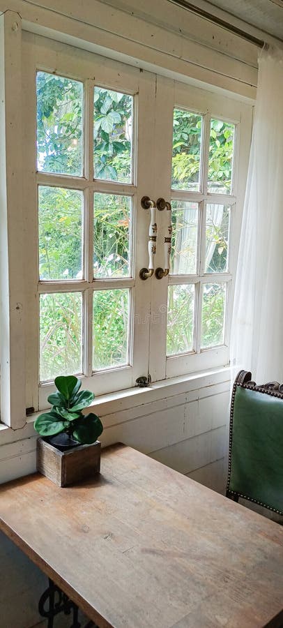 The Retro-style Window Overlooks the Trees and Shines with Light Stock ...