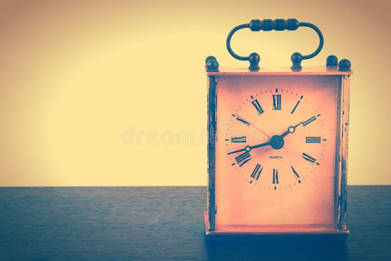 Retro Styled Image of Vintage Square Table Clock on a Wooden Table ...