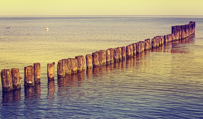 Retro Toned Wooden Posts on the Beach. Stock Image - Image of trip ...