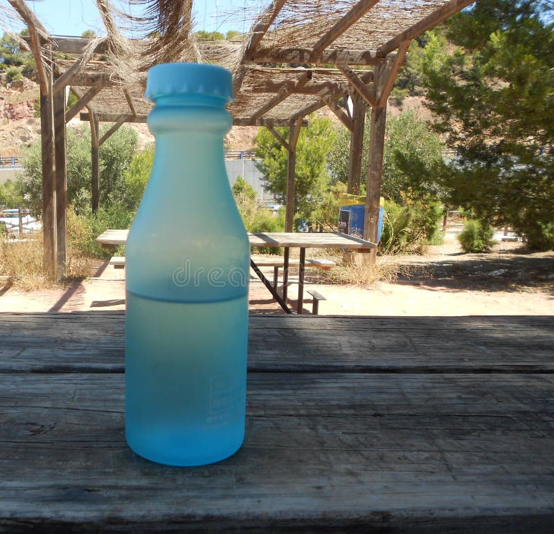 Reusable blue bottle stock photo. Image of bottle, vegetation - 161293792