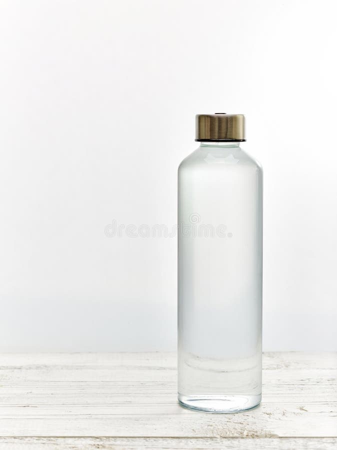 Reusable Glass Drinking Water Bottle on White Table Stock Image - Image ...
