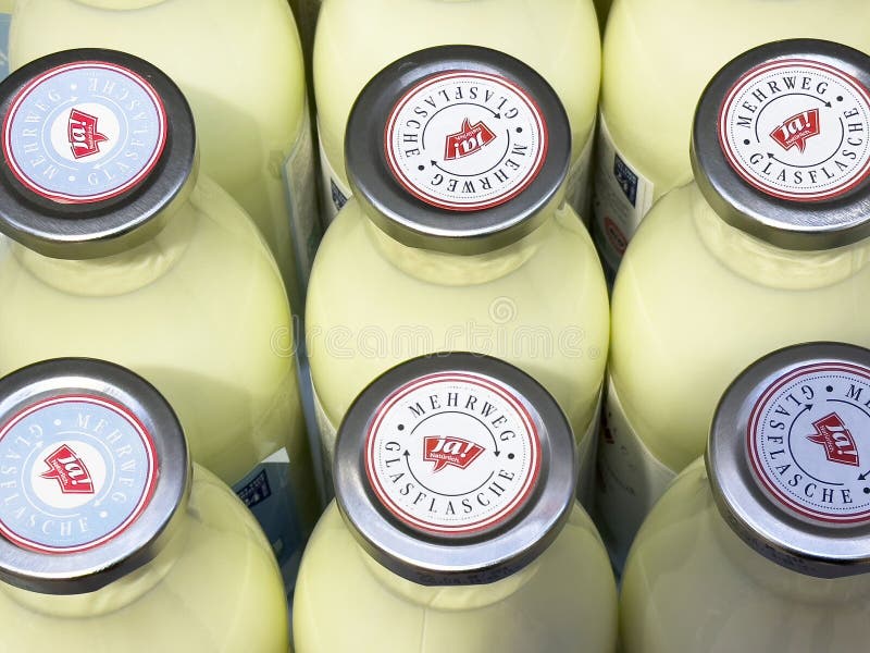 Reusable Glass Milk Bottles with Metal Lids Arranged in a Grid Pattern ...