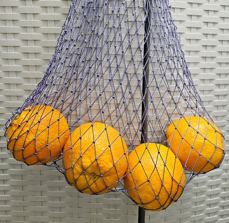 Reusable Thread Mesh Filled with Oranges Hanging on the Pantry Door ...