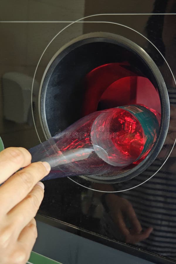 Reverse Vending Machine. Woman Put Empty Plastic Bottle in the Machine ...