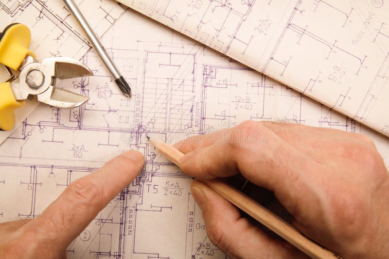 Reviewing Technical Drawings Stock Photo - Image of tilted, single ...