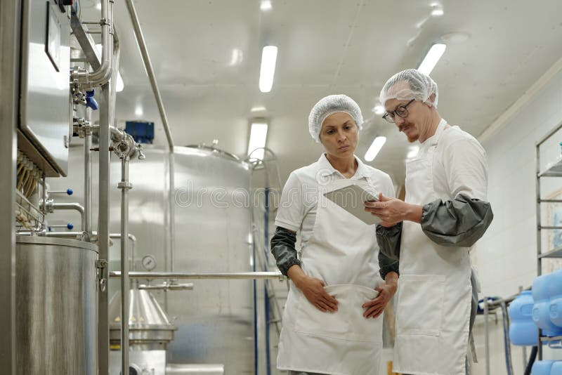 Reviewing Tasks on Digital Tablet in Industrial Kitchen Stock Photo ...