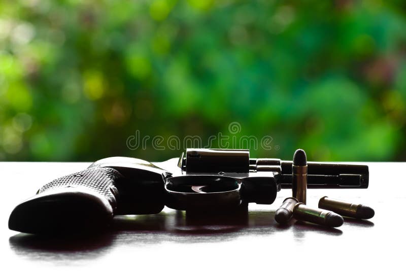 Revolver with Bullets on the Table Stock Photo - Image of holding ...