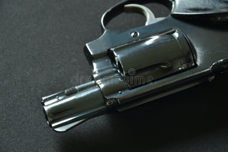 Revolver Gun Muzzle with Smoke Floating in the Air after Shoot on Black ...