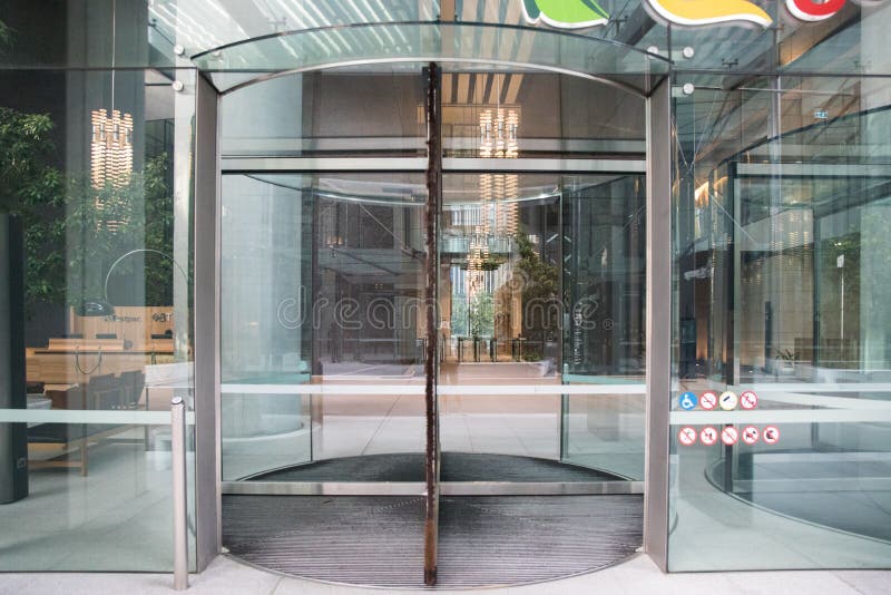 Revolving Glass Doors in Office Building Stock Image - Image of turning ...