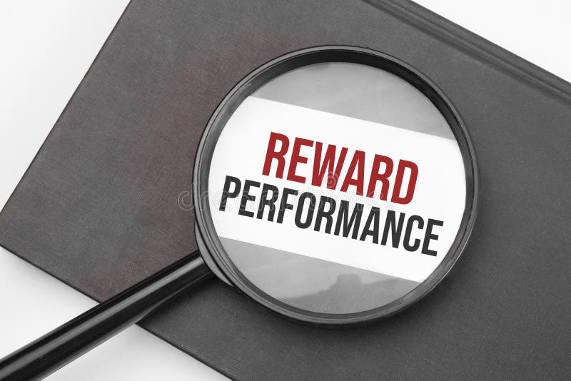REWARD PERFORMANCE Word on Paper through Magnifying Lens Stock Photo ...