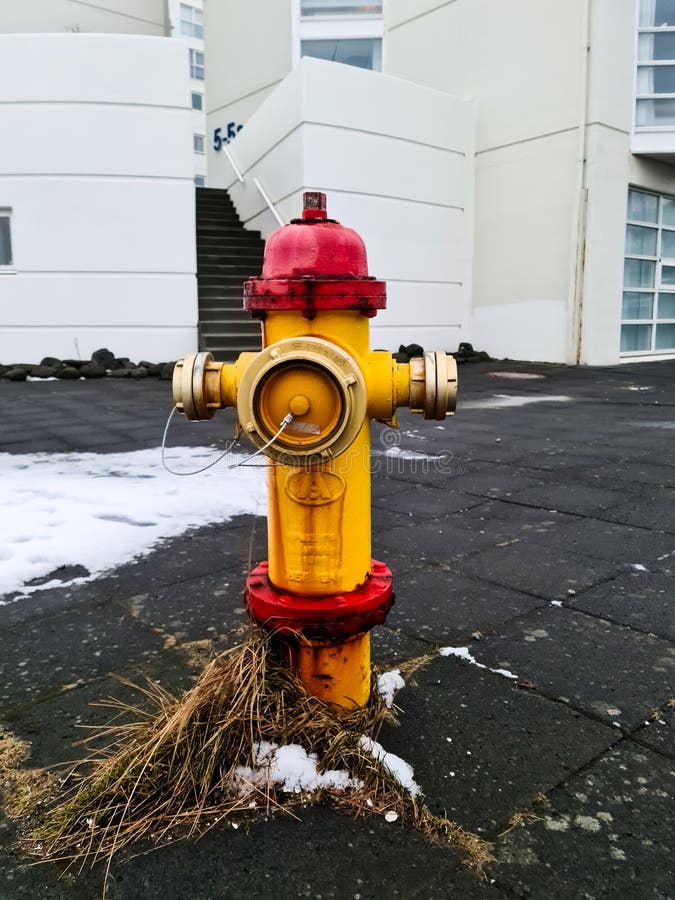 Red and Yellow Fire Hydrant Standing on a Sidewalk in Reykjavik ...