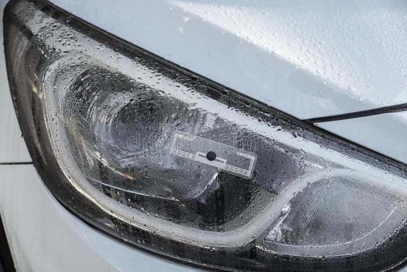 An RFID Tag Sticker on the Headlight of a Pearl White Car Stock Image ...