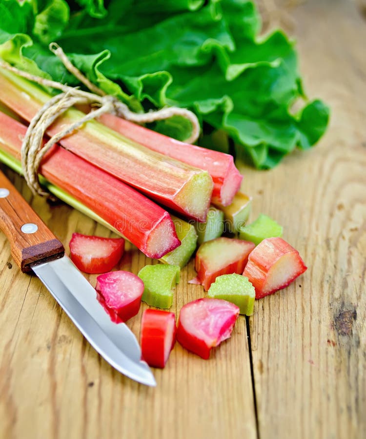 Rhubarb Cut with a Knife on a Wooden Board Stock Photo - Image of ...