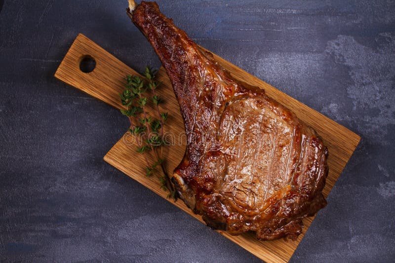 Rib Eye Beef Steak with Thyme on Chopping Board Stock Image - Image of ...