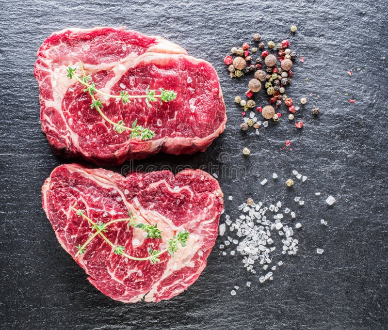 Rib Eye Steaks with Spices on the Black. Stock Image - Image of salt ...