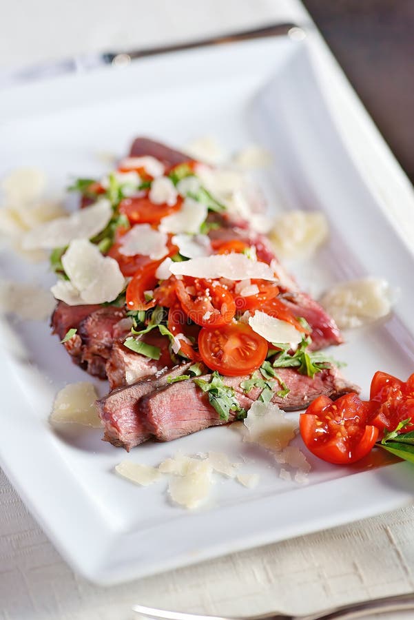 Ribeye Steak on the Bone Sliced in a Rectangular Dish Stock Photo ...