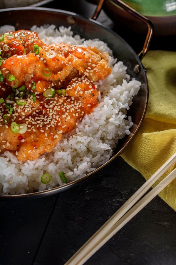 Deep-Fried Orange Chicken Served on a Bed of Steamed White Rice ...