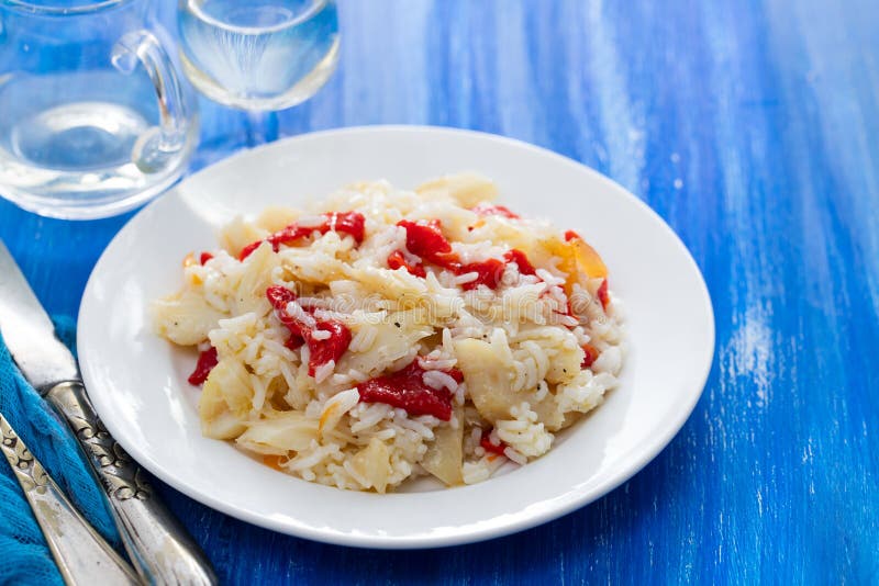 Rice with Cod Fish and Red Pepper on White Dish Stock Photo - Image of ...