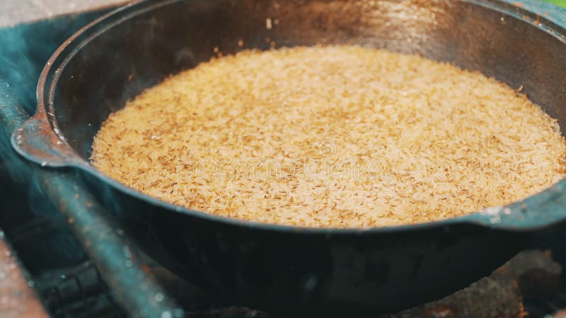 Rice is Cooked in Cauldron on Fire. Stock Video - Video of fried ...