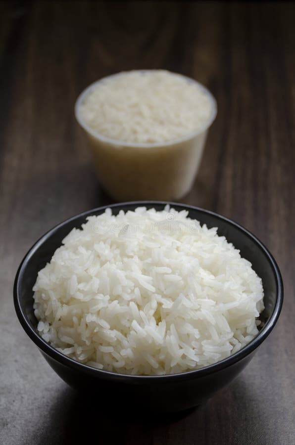 Rice in Cup on Wooden Table Blurred Stock Photo - Image of side ...