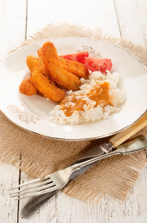 Rice with Curry Sauce and Breaded Chicken Nuggets Stock Image - Image ...