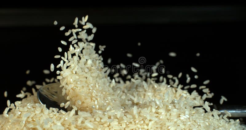 Rice Falling Against Black Background Stock Photo - Image of indoors ...