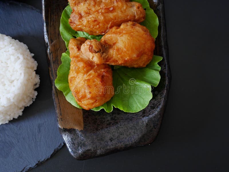 Rice and Fried Chicken on Black Background Stock Image - Image of spoon ...